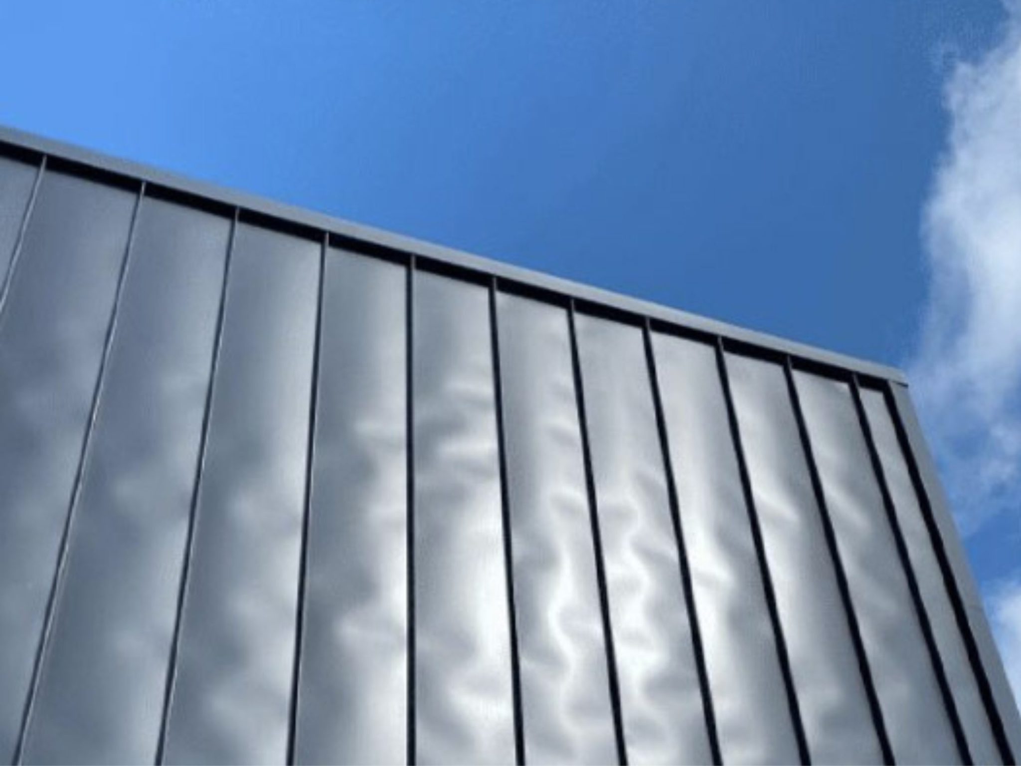 How to Identify and Solve Oil Canning in Metal Roofs - Reimagine Roofing